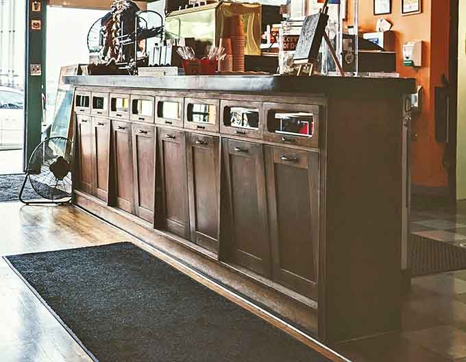 The counter setup shows that serious coffee equipment and welcoming vibes can absolutely coexist in perfect harmony.