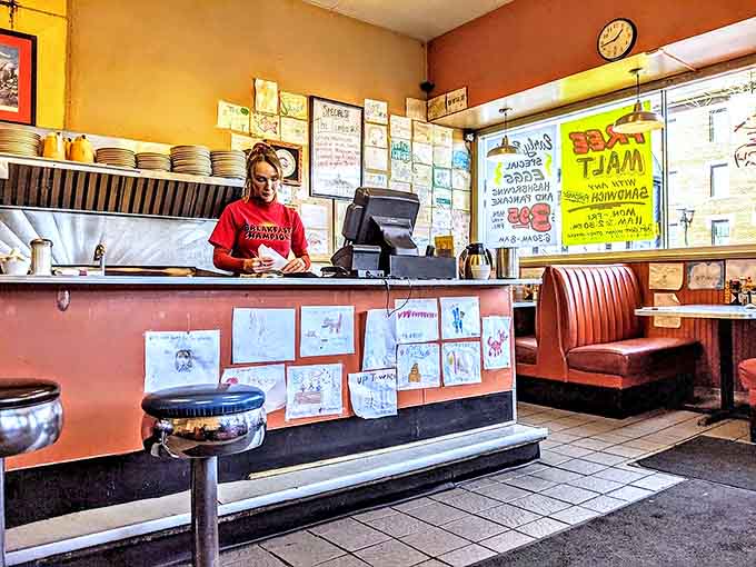 The bustling counter, where regulars perch on swivel stools and servers perform the daily dance of plates and coffee refills.