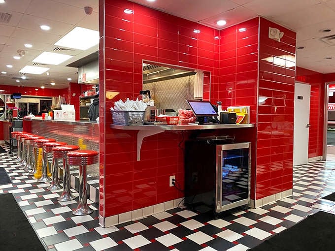 Counter seating: Coral-colored stools invite you to belly up to the counter where the real show happens &ndash; food delivery by miniature locomotive.