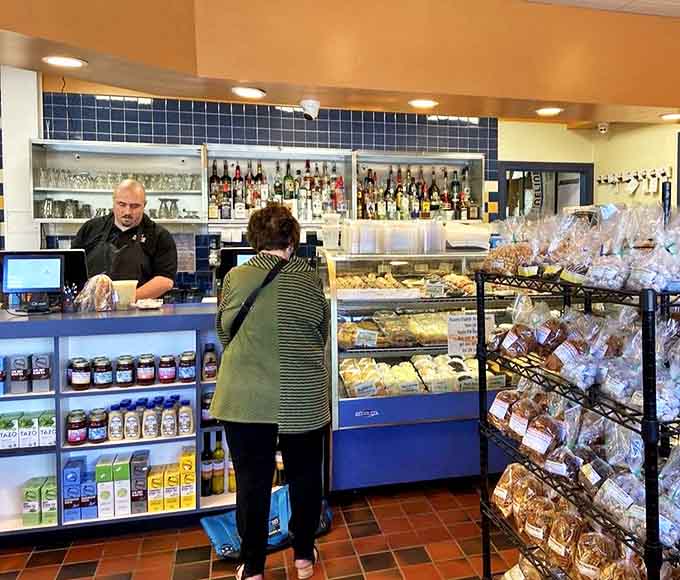 The deli counter experience, where friendly staff help you navigate a world of take-home treasures and freshly baked goods.