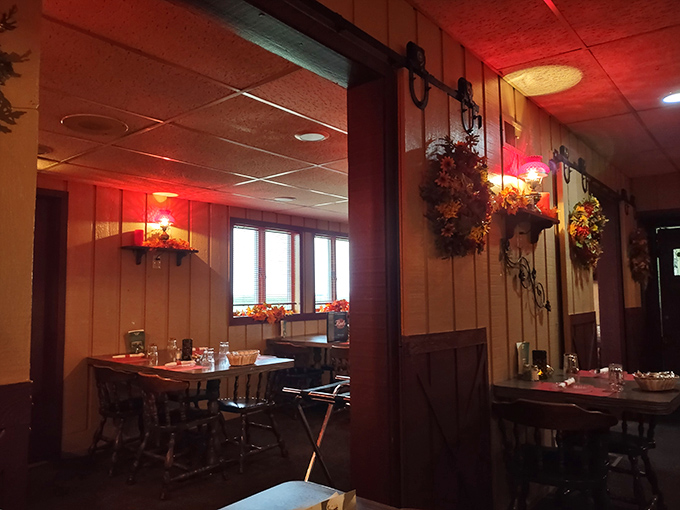 The dining room balances intimacy with spaciousness &ndash; red-tinted lighting and wood paneling create the perfect atmosphere for savoring every bite.