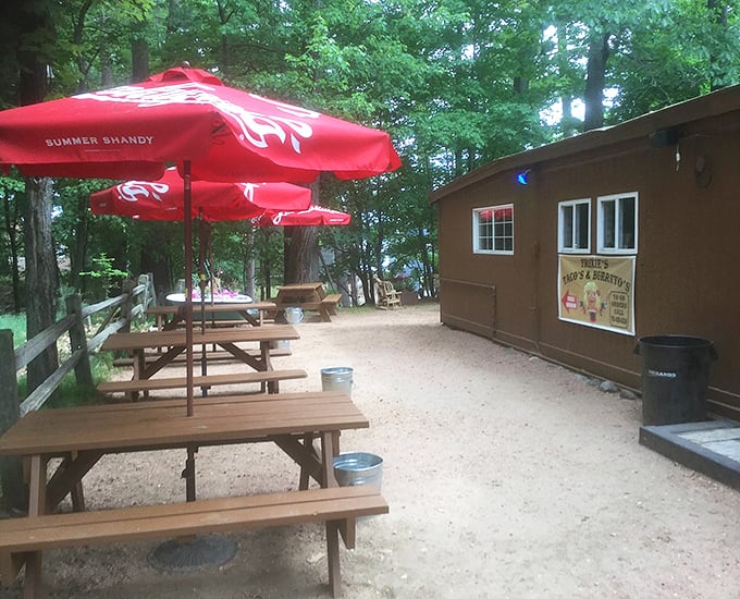 Outdoor seating provides a peaceful retreat under red umbrellas, perfect for summer evenings in Minocqua.