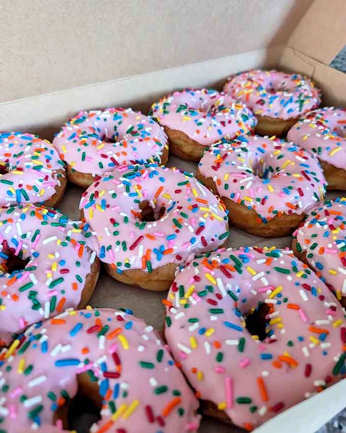 Pink-frosted happiness topped with rainbow sprinkles &ndash; the kind of donut that makes adults feel like kids again.