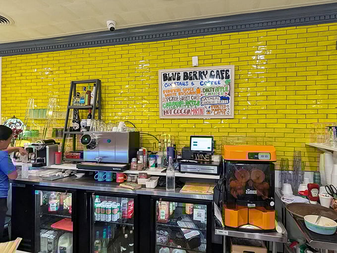 The caf&eacute;'s vibrant yellow brick wall and coffee station &ndash; command central for morning revival and caffeinated bliss.