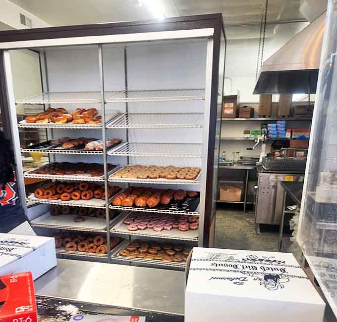 Shelves lined with freshly made donuts offer a glimpse into paradise &ndash; each tray a canvas of culinary artistry awaiting lucky customers.