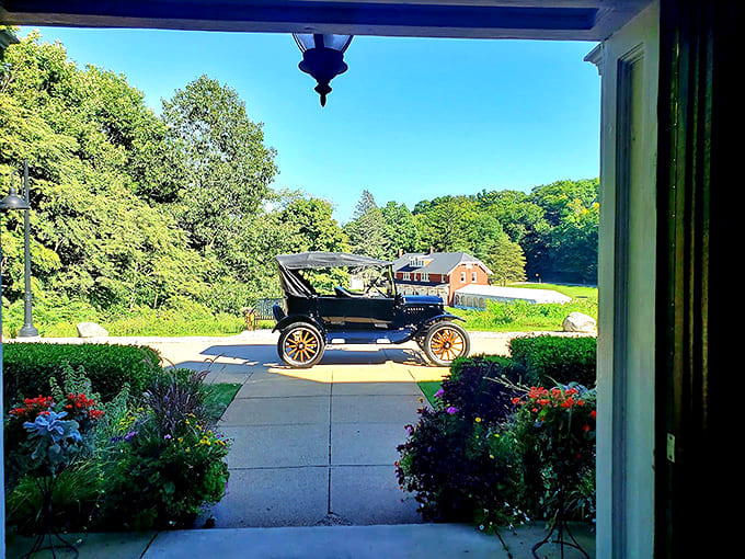 Felt Estate Carriage Drive: A vintage automobile stands sentinel on the drive, a mechanical time traveler surrounded by meticulously maintained gardens.