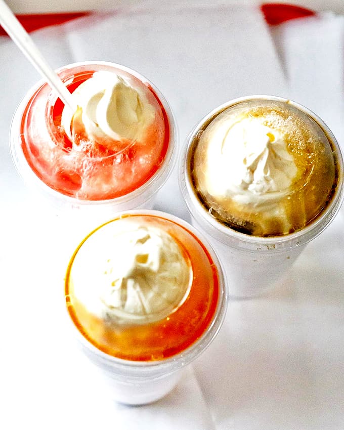 Creamy islands of vanilla ice cream slowly melt into colorful seas of soda &ndash; childhood nostalgia served in a plastic cup.