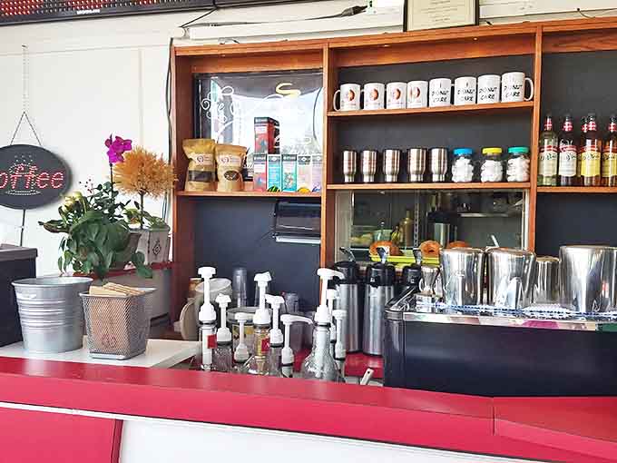 The service counter combines efficiency with warmth, where coffee equipment stands ready to fuel morning adventures.