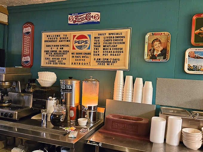 The kitchen wall tells the story – daily specials, Early Bird offerings, and the proud declaration "We serve anybody!" sum up Fred's welcoming philosophy.