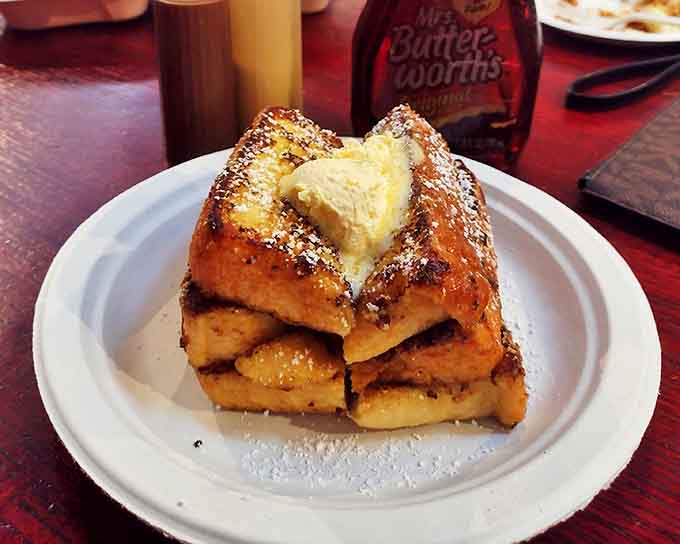 French toast stacked high and dusted with powdered sugar, because sometimes breakfast needs to feel like dessert that's socially acceptable.