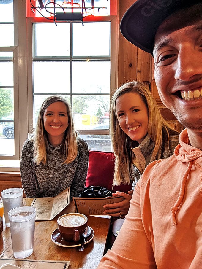 Happy patrons enjoying what might be the highlight of their Traverse City visit – those smiles aren't just for the camera, they're sandwich-induced euphoria.