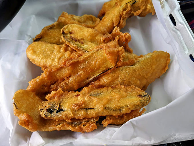 Crispy, golden-battered pickle spears that deliver the perfect tangy crunch &ndash; proof that anything becomes magical when properly fried.