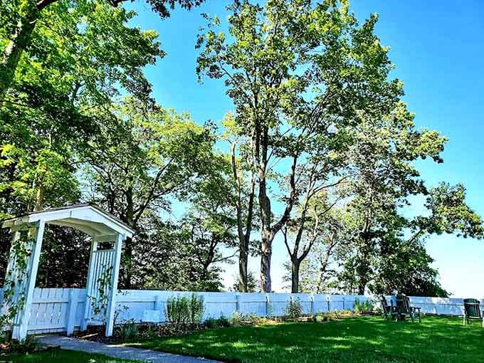 White picket fences and garden arbors frame the lighthouse grounds, creating picture-perfect vignettes that beg to be photographed.