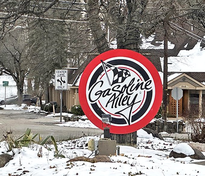 The distinctive red and white Gasoline Alley sign stands out against the winter landscape, a beacon for hungry travelers.