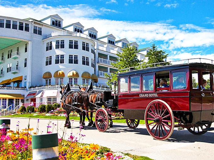 The clip-clop of hooves announces the hotel's signature carriage, a reminder that on Mackinac Island, the journey is as charming as the destination. 