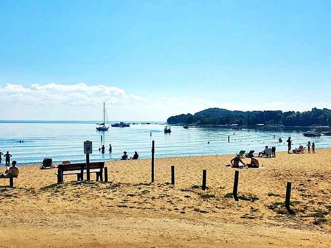 Haserot Beach invites bare feet and carefree spirits, where crystal waters meet golden sand under Michigan's endless summer sky.