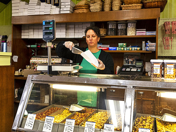 Skilled hands at work &ndash; decades of candy-making expertise go into every carefully weighed and packaged sweet treasure.