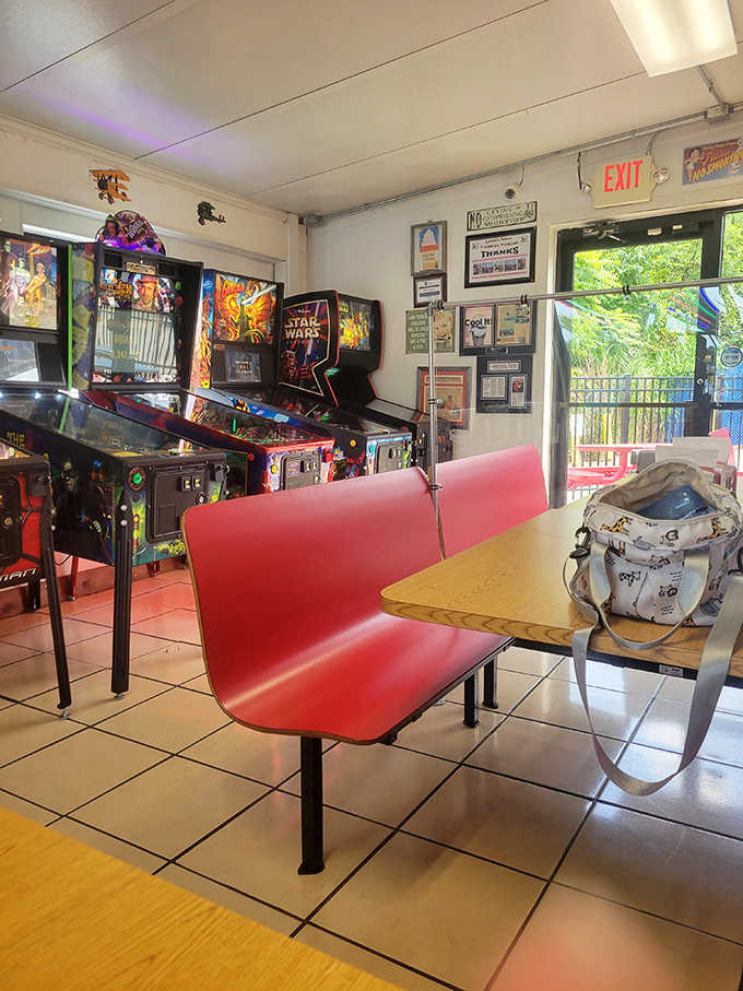 Red bench seating and classic pinball machines create a retro atmosphere where time seems to slow down between bites of ice cream.