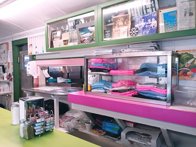 Even the shelving looks like it could tell stories, painted in that distinctive pink that says "we've been doing this since before your parents went on their first date."