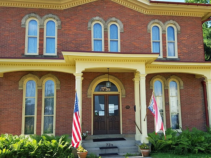 The Monroe House stands as a perfectly preserved Victorian time capsule, its yellow trim brightening even the cloudiest Ohio day.