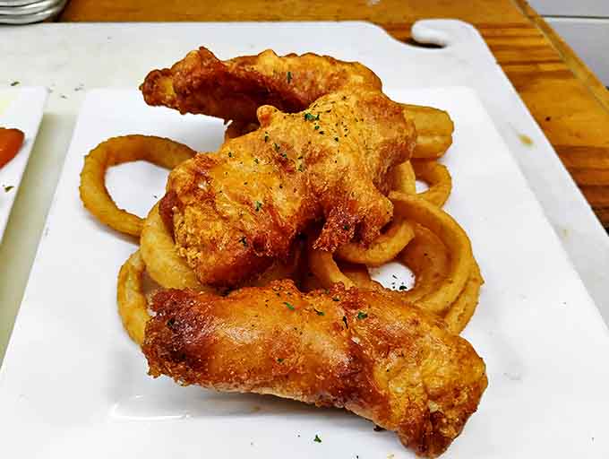 Golden-battered fish rests alongside crispy onion rings &ndash; proof that sometimes the simplest pleasures are the most satisfying.