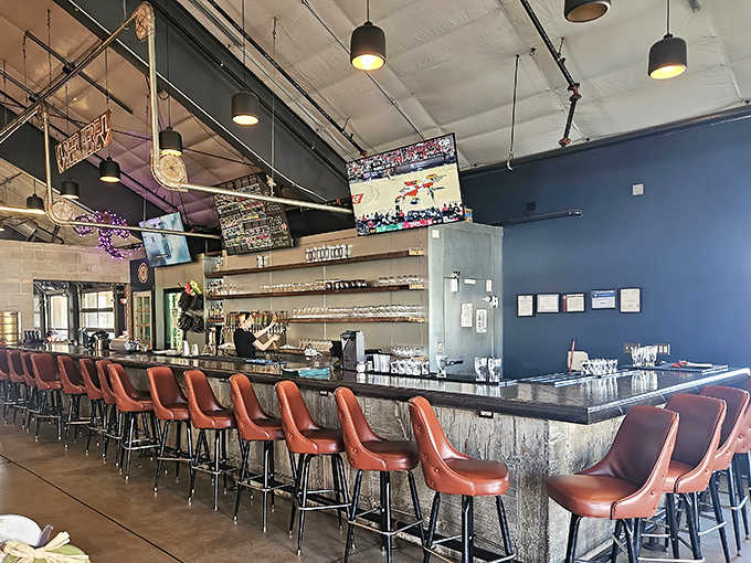 A commanding centerpiece with leather stools inviting you to settle in, where taps stand ready to dispense liquid happiness.