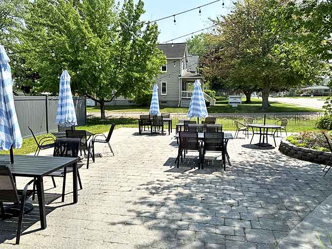 The stone-paved patio offers al fresco dining under string lights, creating a magical atmosphere for warm Michigan evenings.