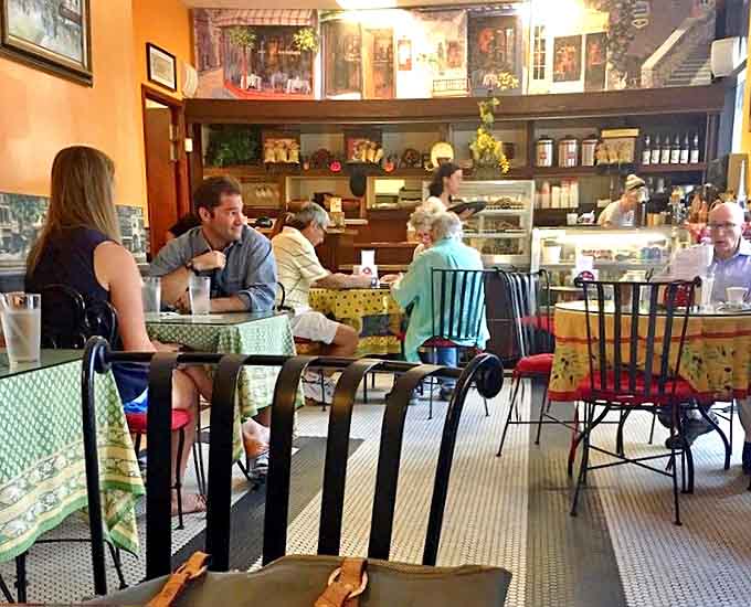 The café's warm interior creates a space where strangers become neighbors, united by the universal language of "mmm" and "can I try yours?"