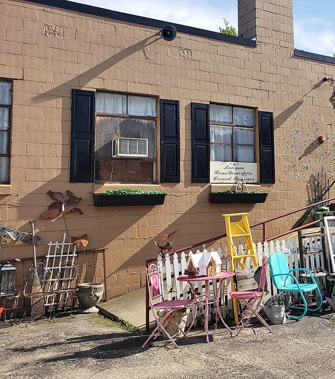 Vintage garden furniture and weathered signs create an Instagram-worthy entrance that's actually authentic, not staged.
