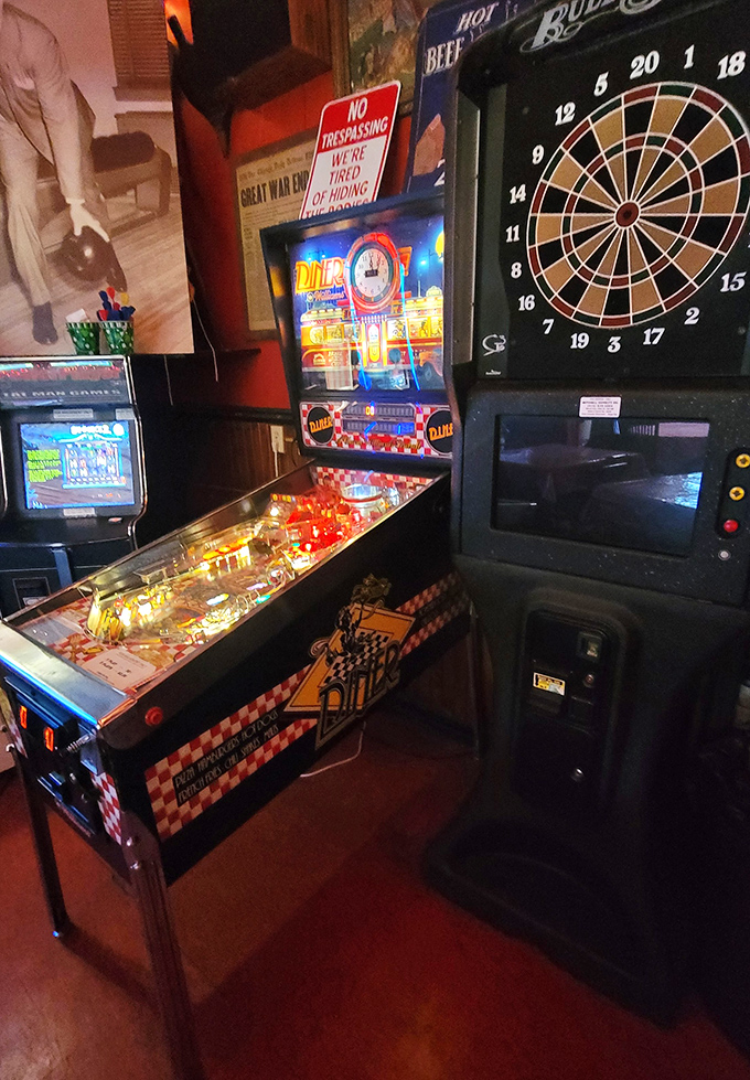 Vintage entertainment options include pinball and darts, perfect diversions while waiting for your turn on the historic lanes below.