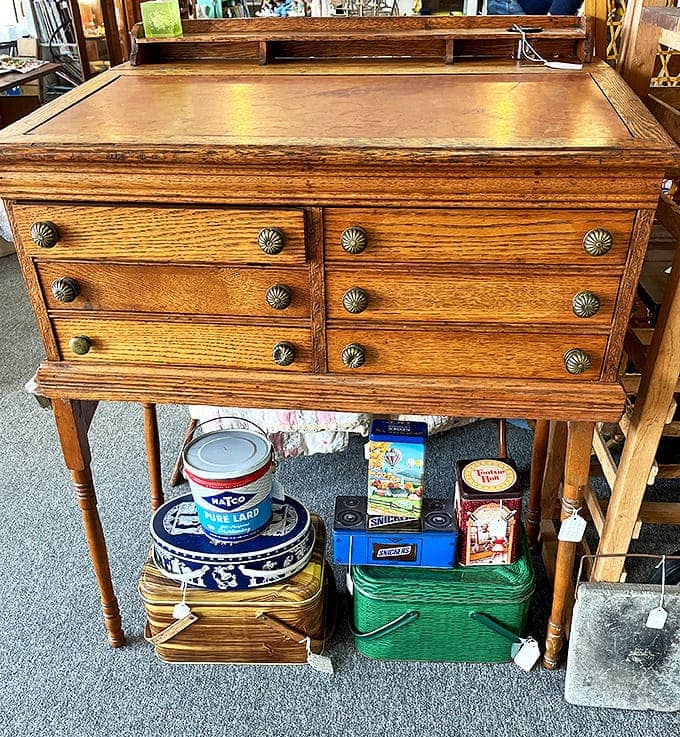 This oak desk with brass hardware has witnessed more history than your high school textbook. Those drawers probably held love letters long before they stored tax forms.