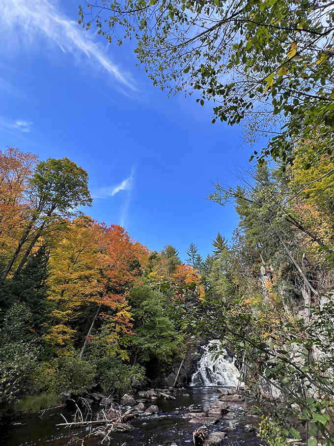 Fall foliage frames the cascading waters in a spectacular display that makes even seasoned travelers stop in their tracks with wonder.