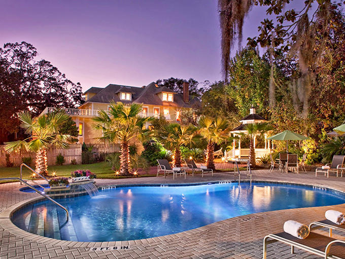 As twilight embraces the property, the illuminated pool creates a magical oasis that even the most proper Victorian would approve of.