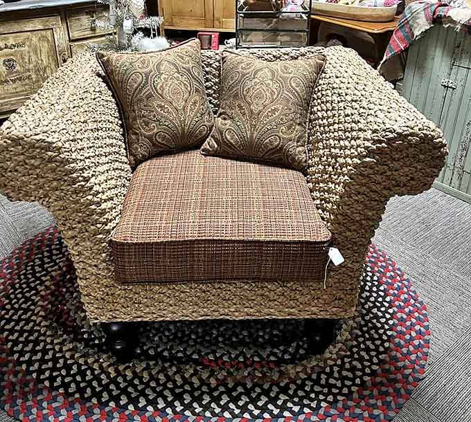 This woven rattan chair with plush cushions isn't just furniture – it's a time machine waiting to transport you back to screened porches and lemonade summers.