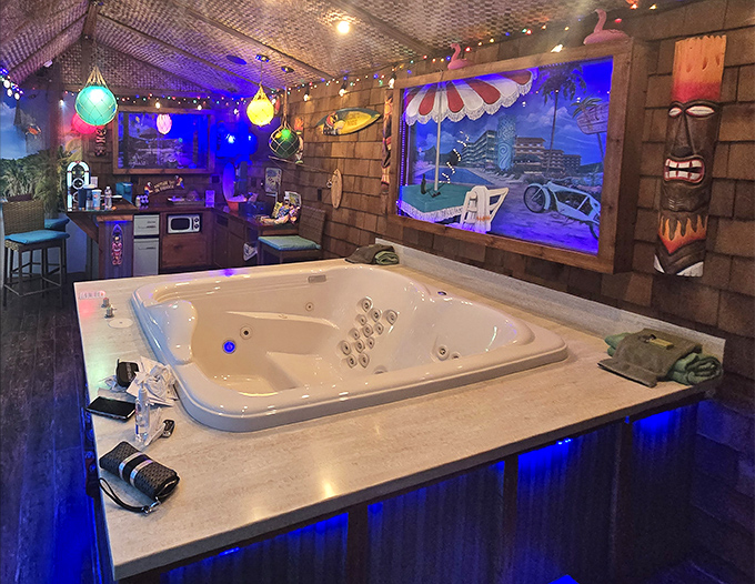 The rainforest-themed room creates an immersive jungle experience, complete with lush greenery and a steaming hot tub oasis.