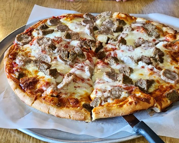 This sausage pizza doesn't need a passport to transport you to flavor country. Each bite delivers a perfect ratio of meat, cheese, and that irreplaceable wood-fired essence.