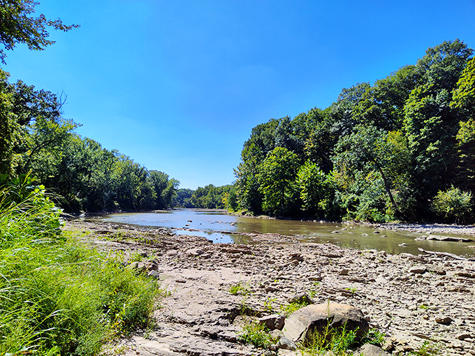 Crystal waters flow gently over ancient stone, carving pathways that have shaped this landscape for countless millennia.