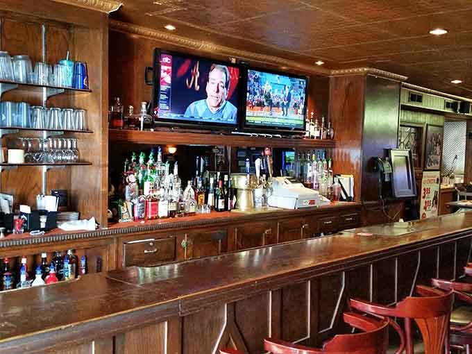 The classic wooden bar serves as command central, where bartenders mix drinks and remember regulars' names with impressive accuracy.