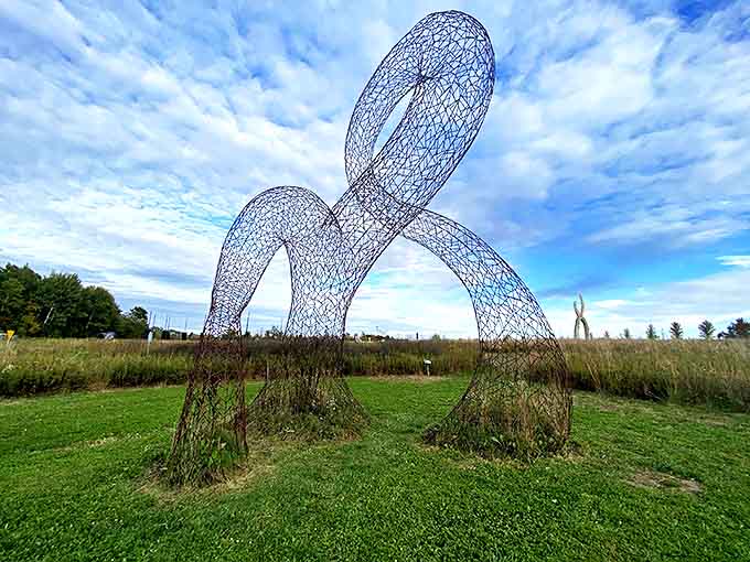 Delicate wire forms dance against the sky, proving that sometimes the most powerful sculptures are the ones that appear almost weightless.