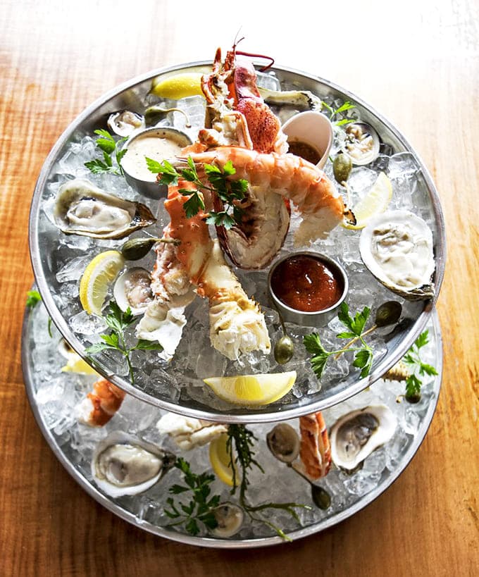 The seafood tower rises from its icy bed like Neptune's personal buffet &ndash; a multi-tiered monument to oceanic delights that demands reverent consumption.