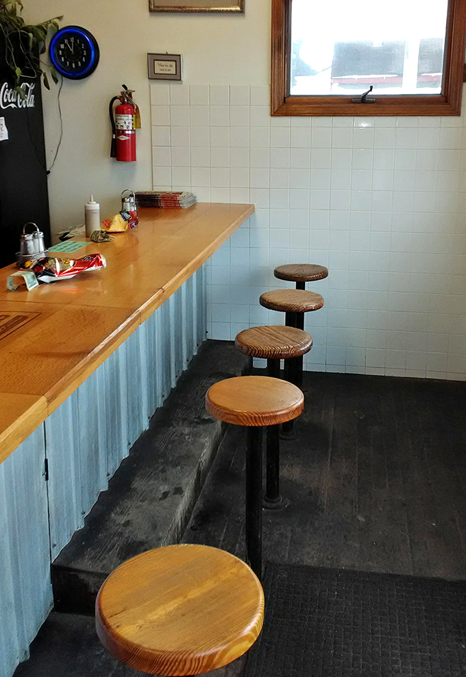Minimalist counter dining at its finest &ndash; these worn wooden stools have supported generations of happy burger enthusiasts.