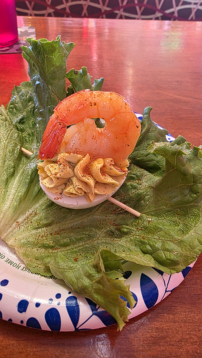 Shrimp Appetizer: A single perfectly cooked shrimp perches atop a deviled egg, proving that sometimes the simplest presentations deliver the biggest flavors.