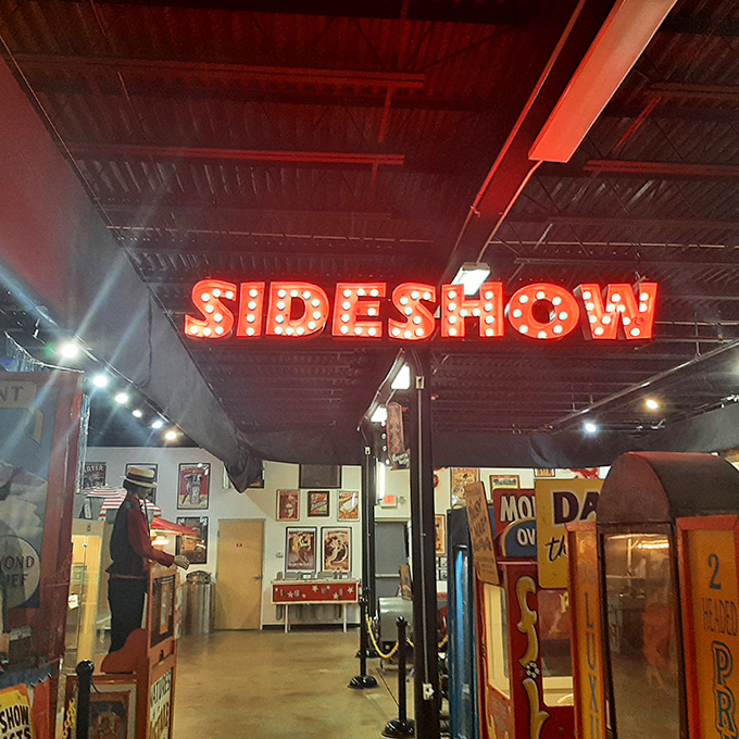 The "SIDESHOW" sign glows with the promise of wonders and oddities &ndash; just as it did when it lured curious visitors with the tantalizing unknown.