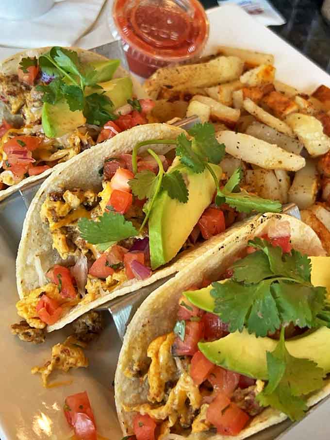 Breakfast tacos loaded with scrambled eggs and topped with avocado&mdash;handheld morning perfection right here.