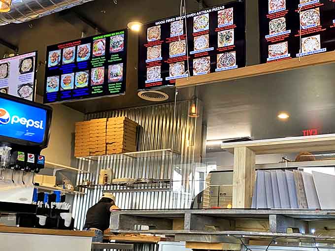 The digital menu board showcases pizza possibilities that will have you planning your next visit before you've finished your first slice.