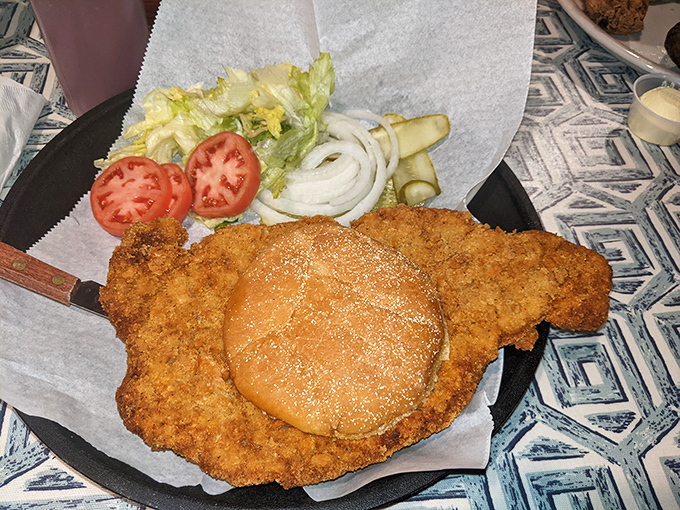 The pork tenderloin sandwich &ndash; hand-breaded, fried to golden perfection, and hanging gloriously off the edges of its bun.
