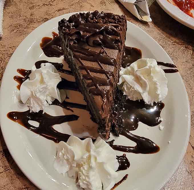 Chocolate cake drizzled with sauce and topped with whipped cream is the sweet ending your meal absolutely deserves.