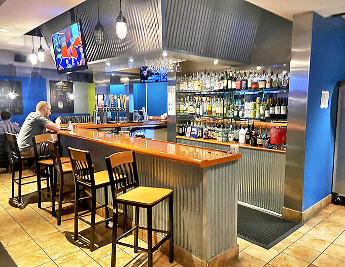 The well-stocked bar area offers a perfect perch for solo diners or those looking to pair their burger with something stronger than soda.