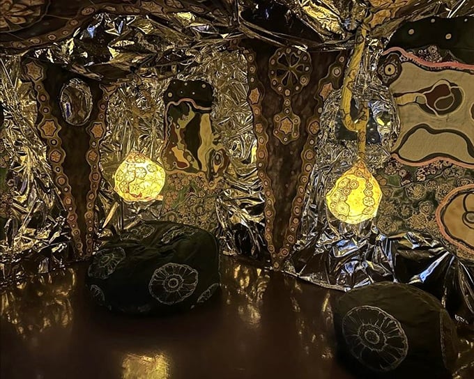 Gold and bronze reflections create a cave of wonders &ndash; where every surface shimmers with metallic possibility.