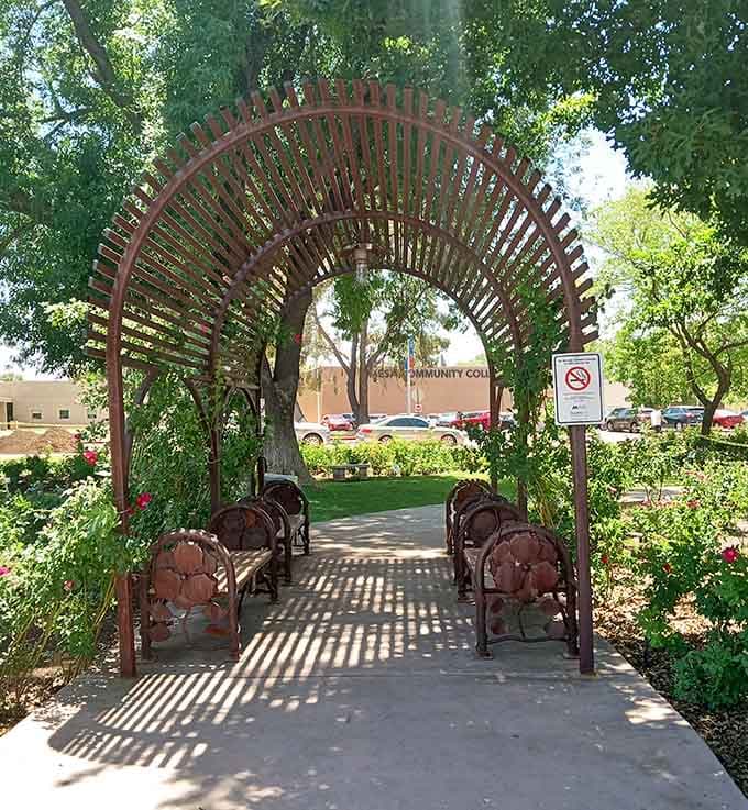 Decorative metal archways frame romantic seating areas where couples can rest, chat, and pretend they're starring in their own garden romance.
